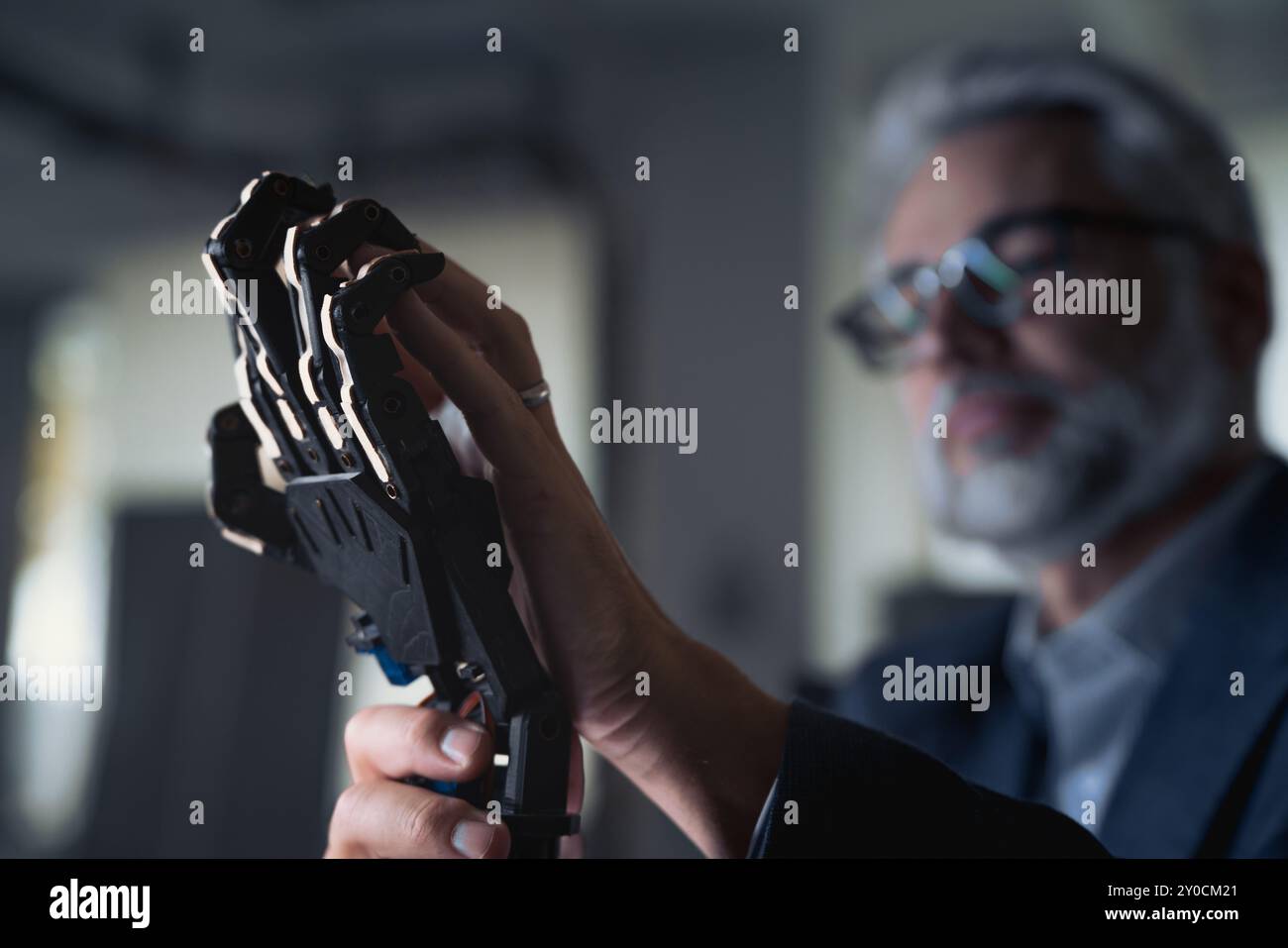 Robotics engineer adjusting, calibring robotic prosthetic hand. Concept ...