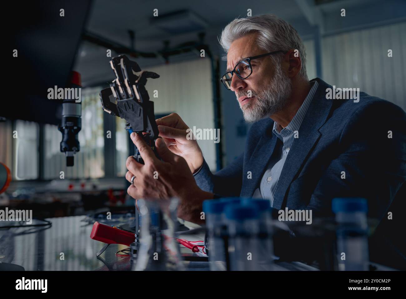 Robotics engineer adjusting, calibring robotic prosthetic hand. Concept ...