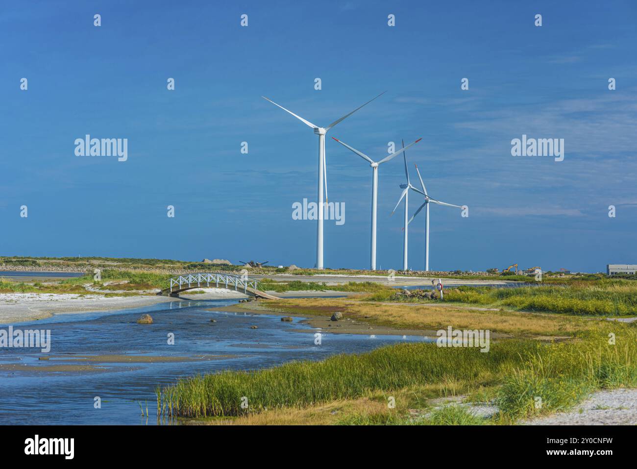 Four wind turbines by a bay and a small beach Stock Photo - Alamy