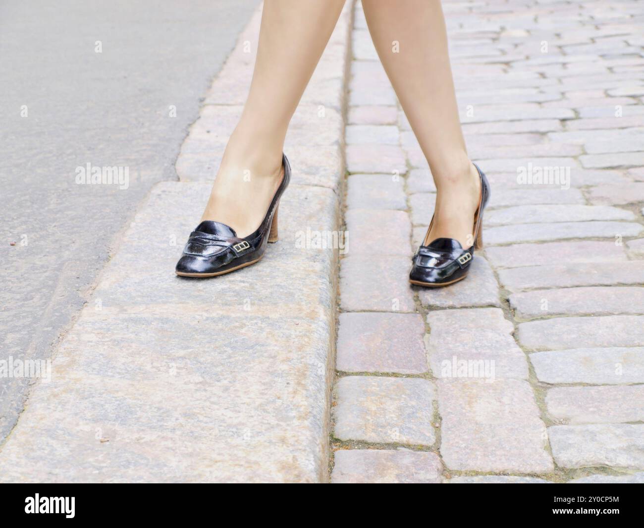 Female stepping onto the sidewalk in a street Stock Photo - Alamy