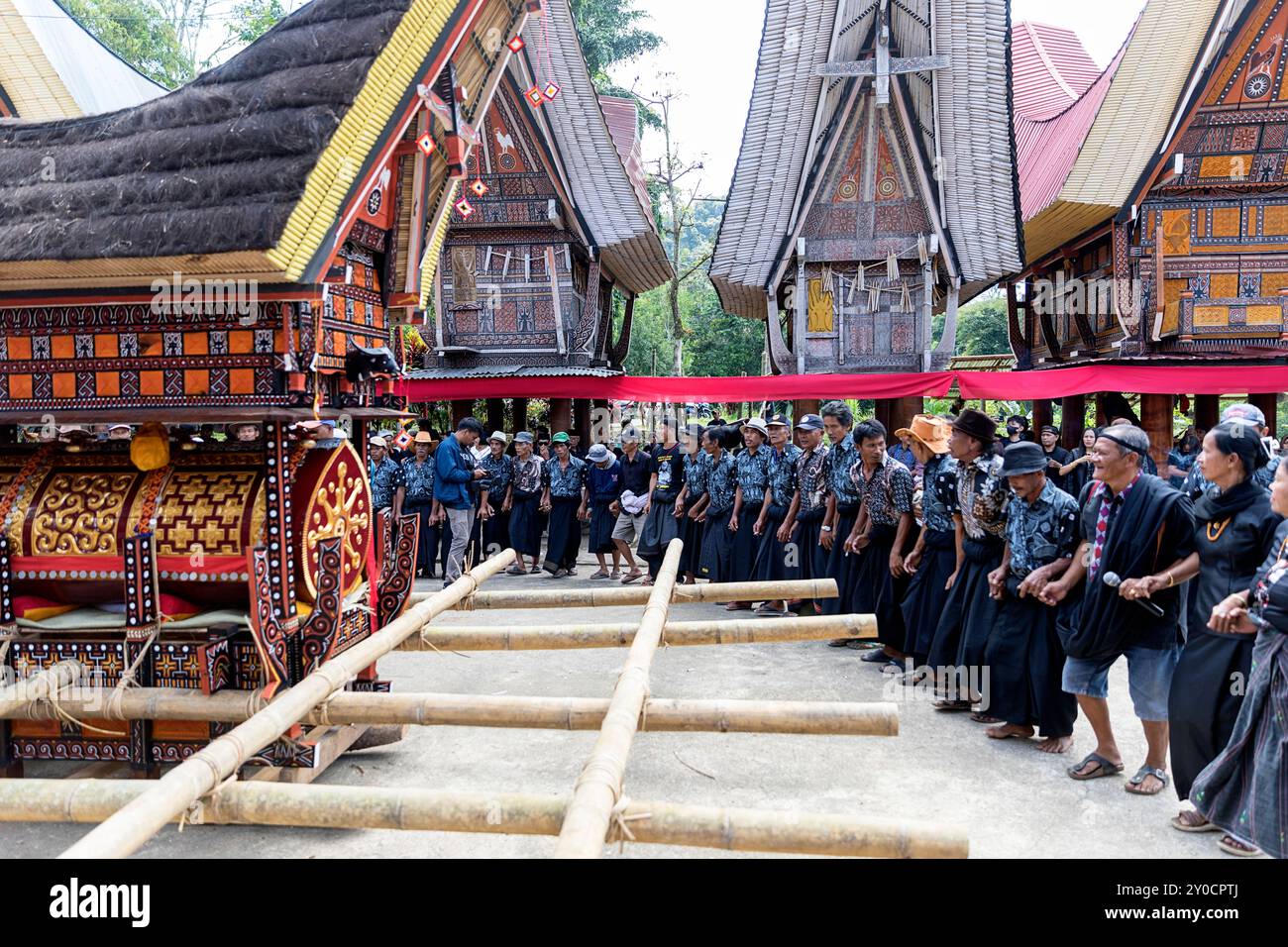 Men singing and dancing between traditional tana toraja houses for ...