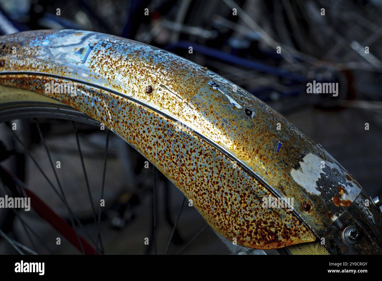 Rust and remnants of stickers on a bicycle mudguard, abstract dark ...