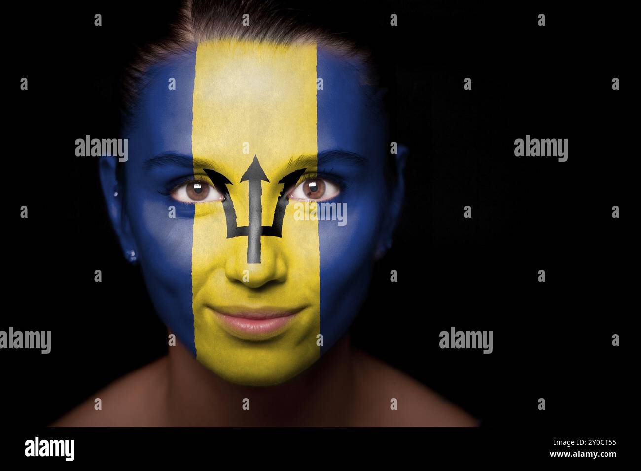 Portrait of a woman with the flag of the Barbados painted on her face ...