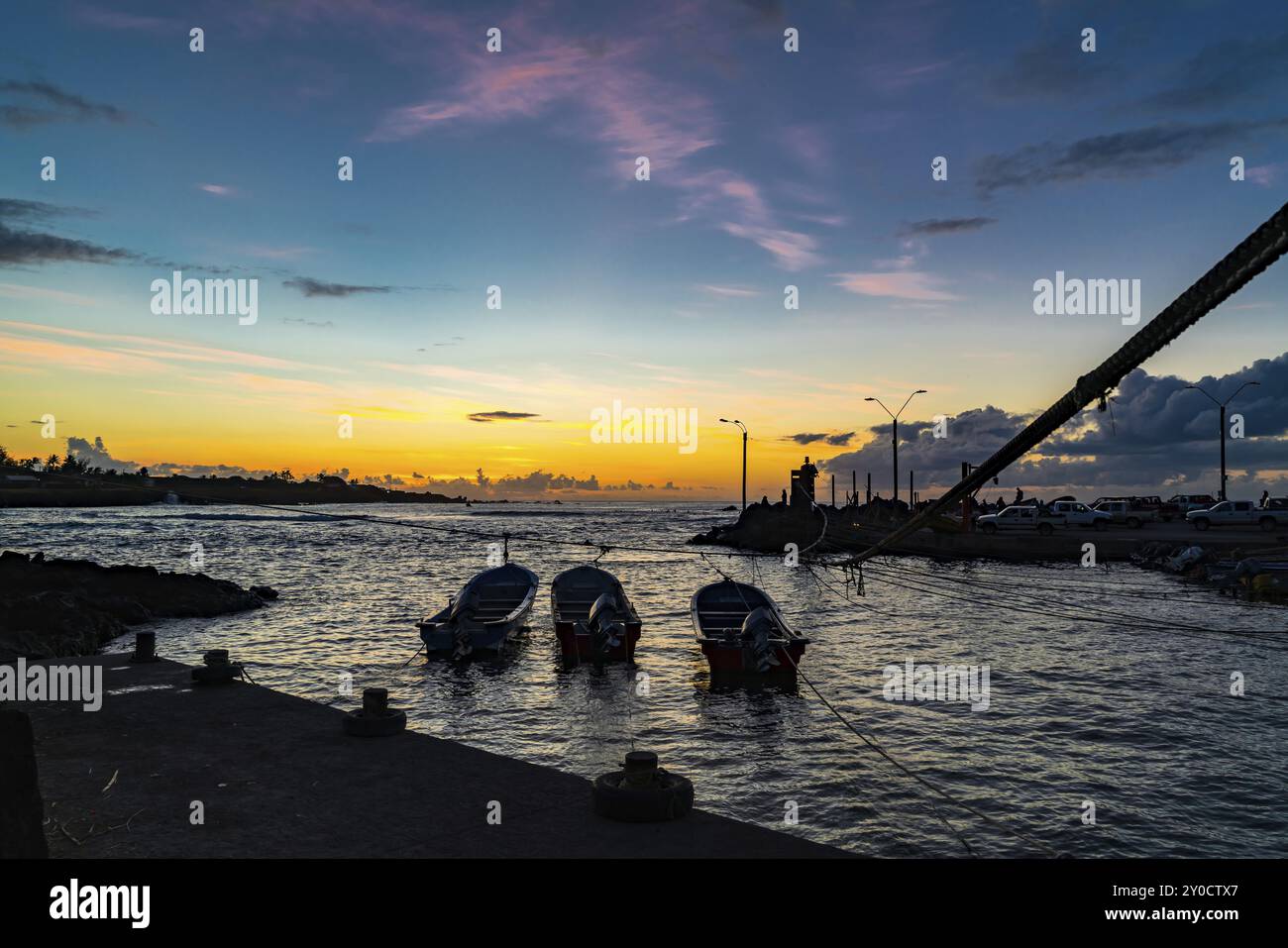 Silhouette of fisherman port of Hanga Roa Village at sunset in Easter ...