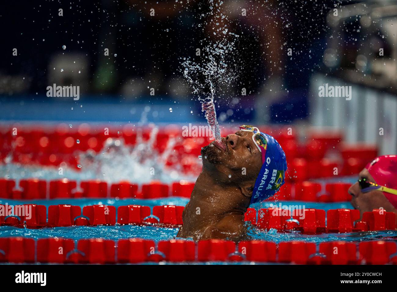 Paralympic athlete Araujo dos Santos, of Brazil, spits water to ...