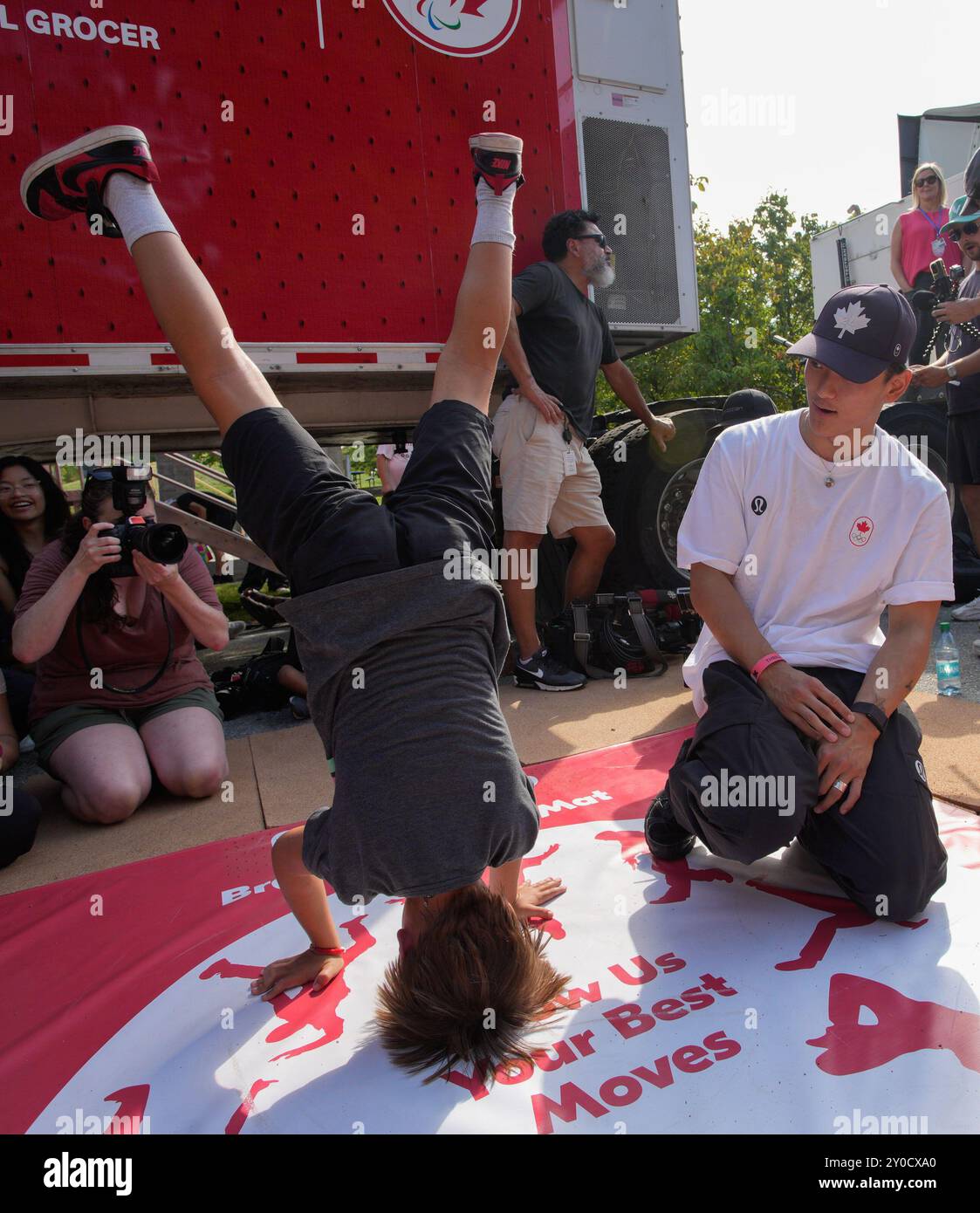 Vancouver, Canada. 1st Sep, 2024. Kim Philip (R) looks on as a child ...