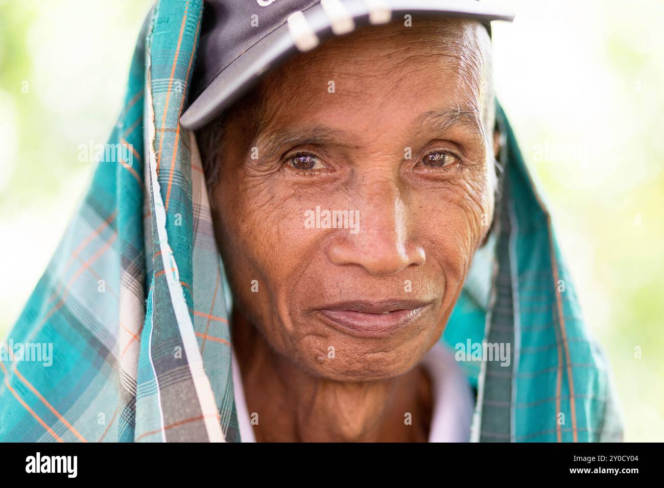 Portrait of a local man with a hat and textile cloth on his head ...