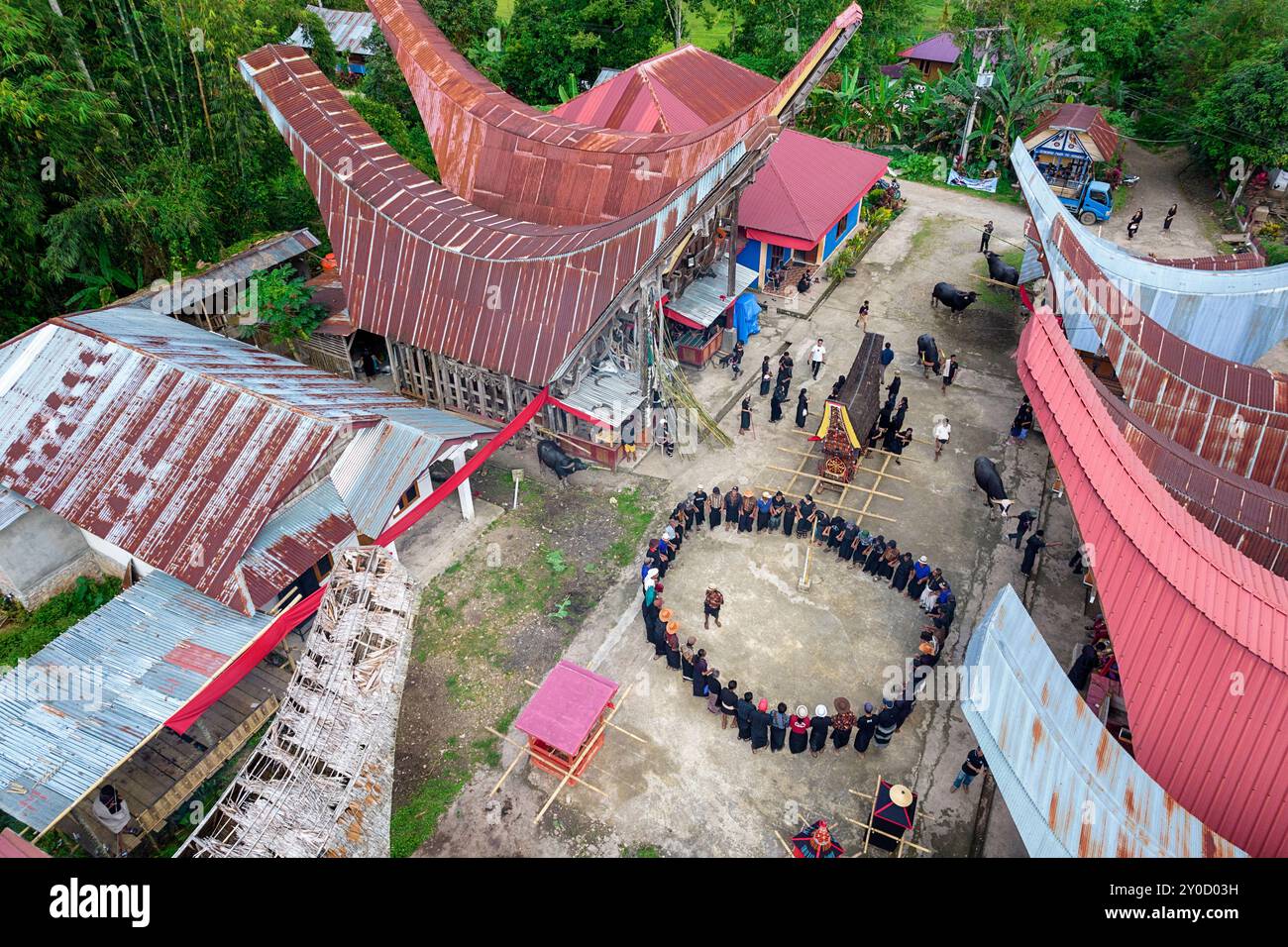 Local men singing and dancing in a circle in the yard between ...
