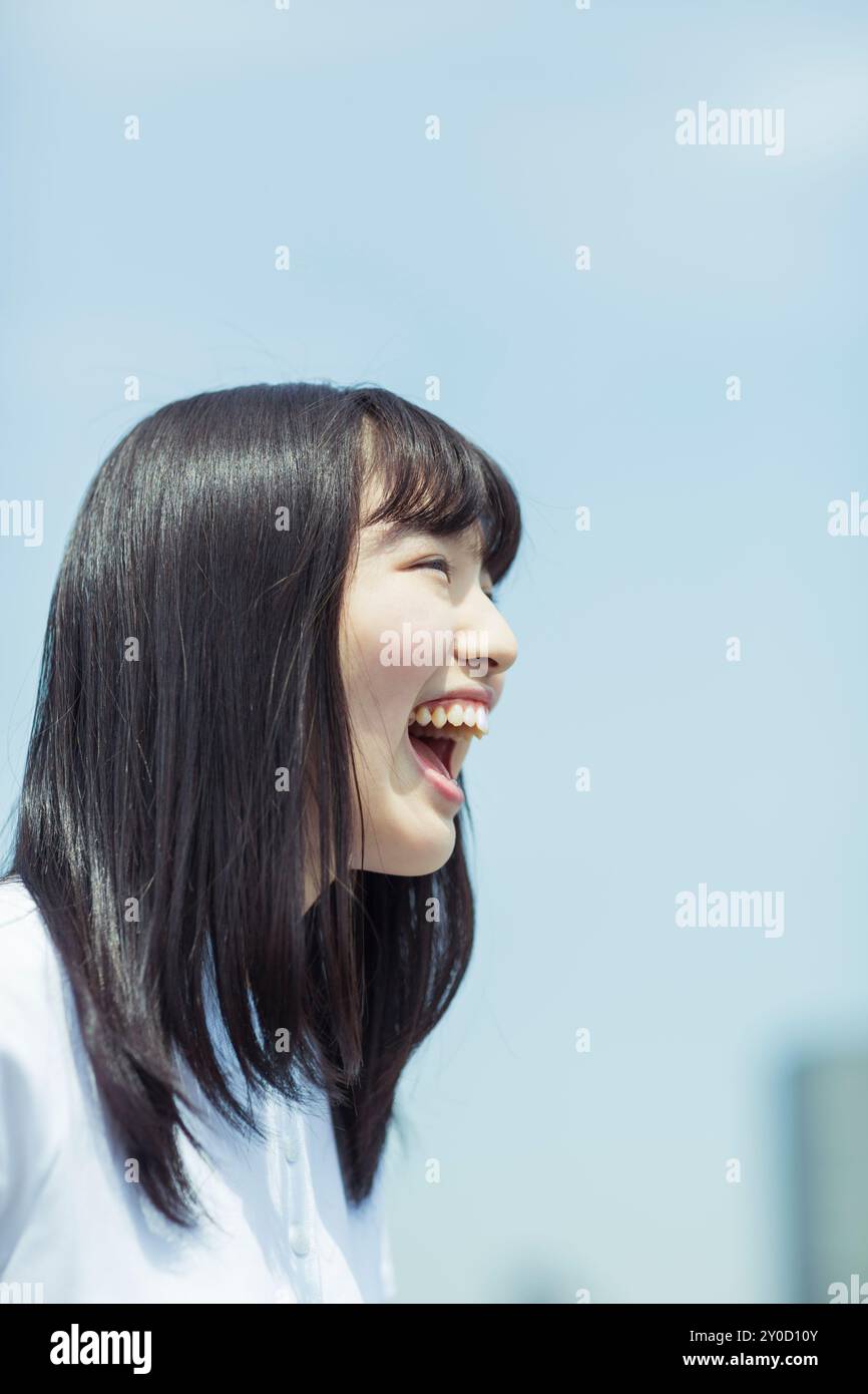 A smiling high school girl calling out Stock Photo - Alamy