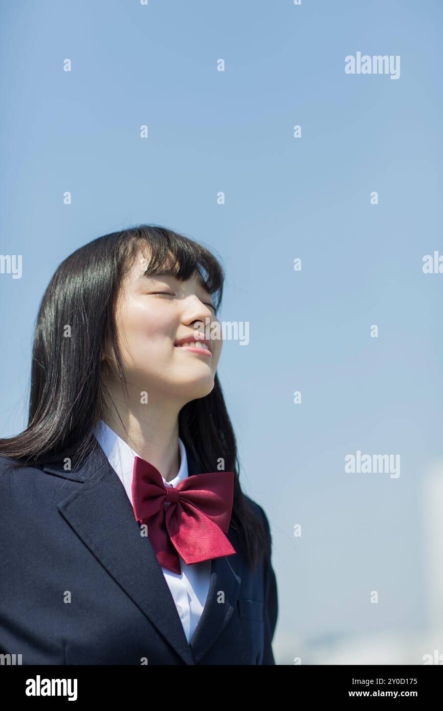 A high school girl facing up with her eyes closed Stock Photo - Alamy