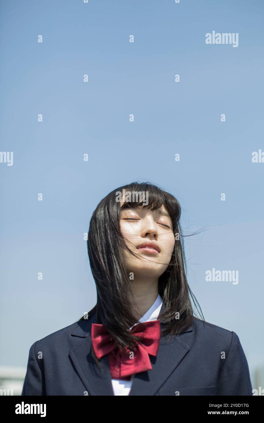 A high school girl with her eyes closed Stock Photo - Alamy