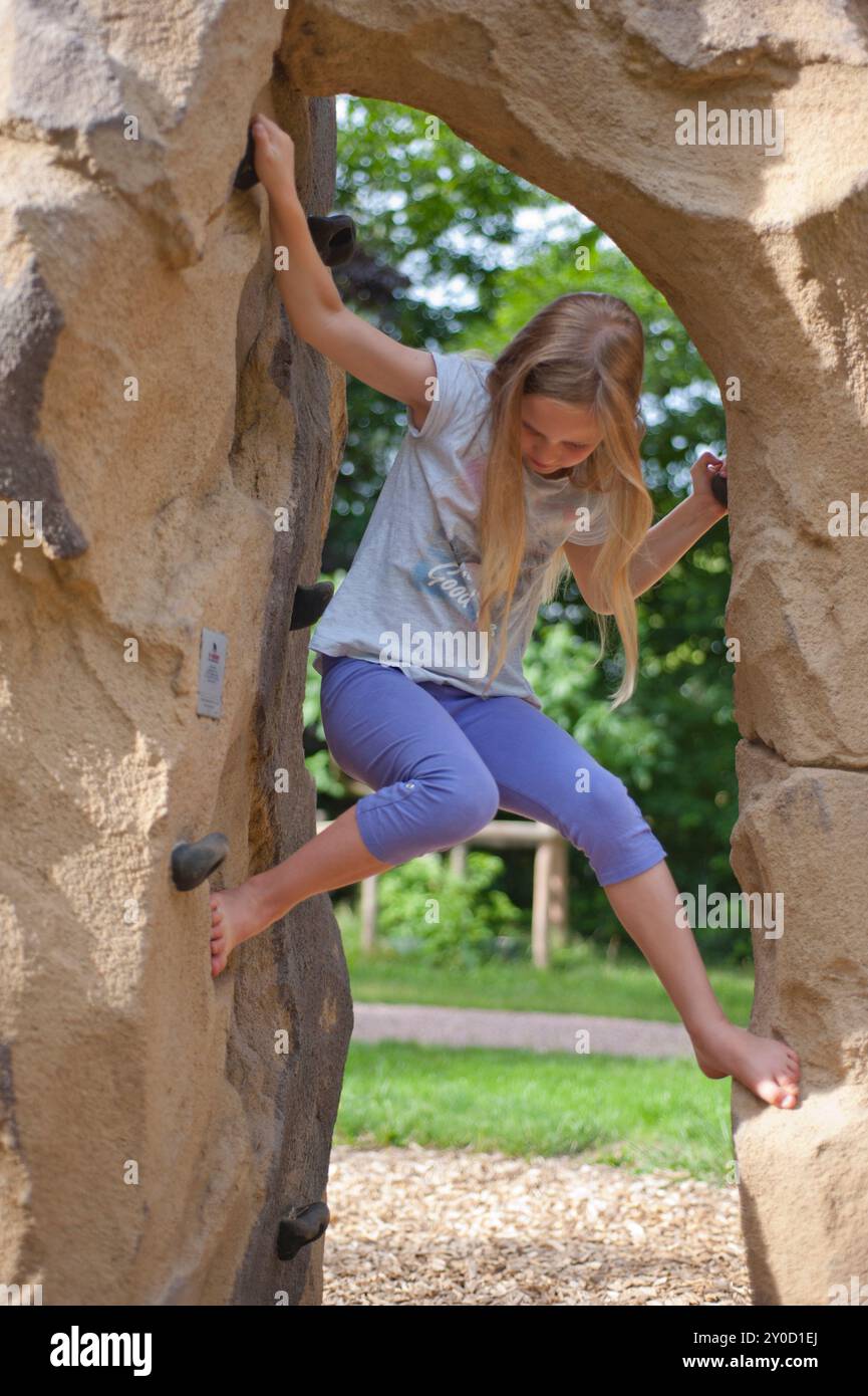 Child climbing rocks in hi-res stock photography and images - Alamy