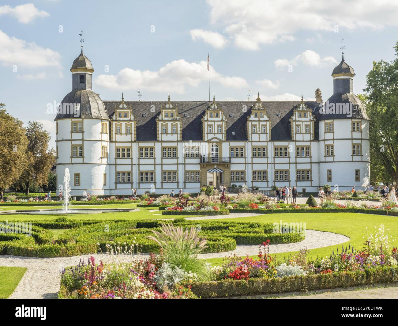 Renaissance-style castle with symmetrical gardens and colourful flowers ...