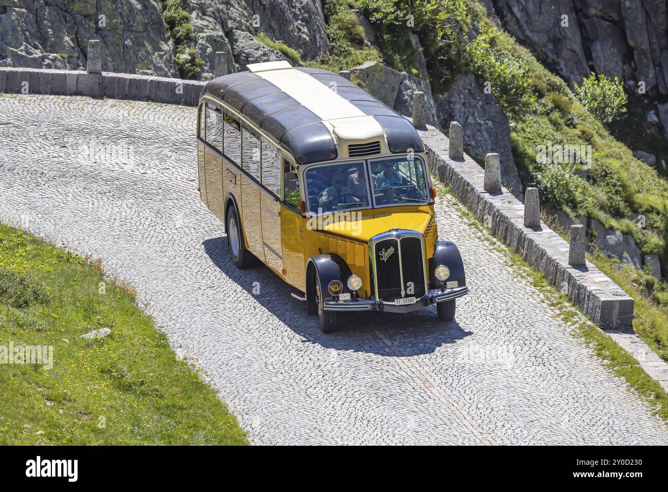 Historic postbus travelling along the Tremola, the world-famous ...