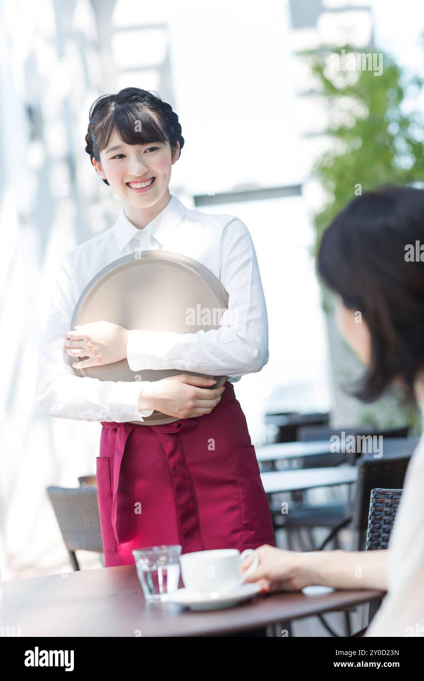 Smiling female cafe waitress hi-res stock photography and images - Alamy