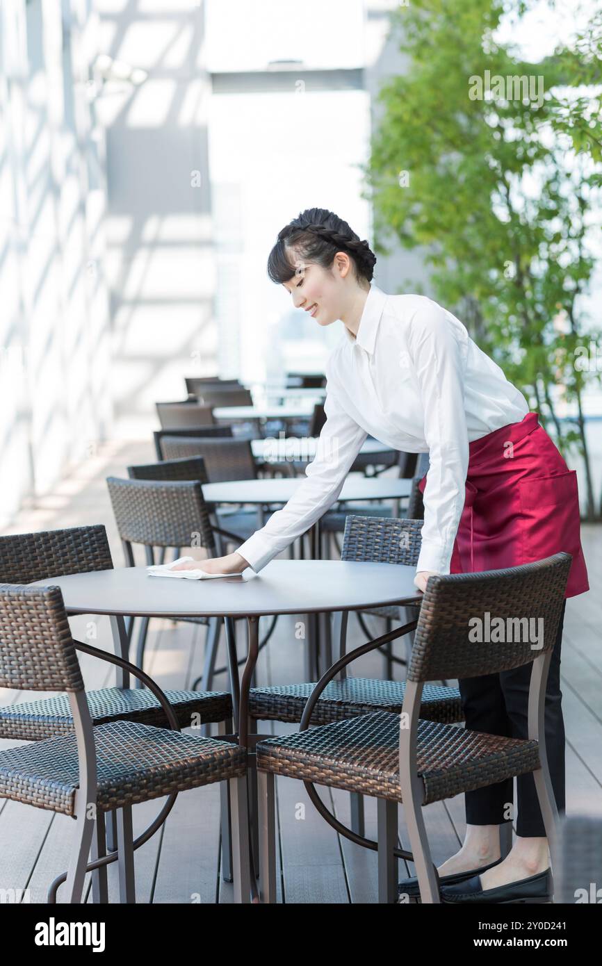 Young waitress wiping table hi-res stock photography and images - Alamy