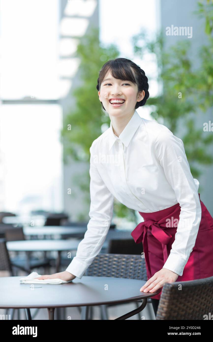 An employee wiping a table Stock Photo - Alamy