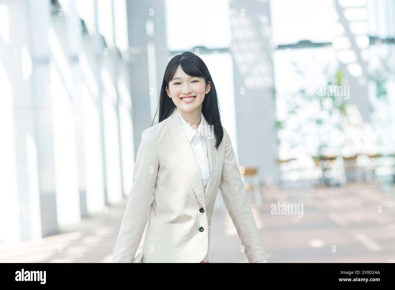 Businesswoman?turning around with smile Stock Photo - Alamy