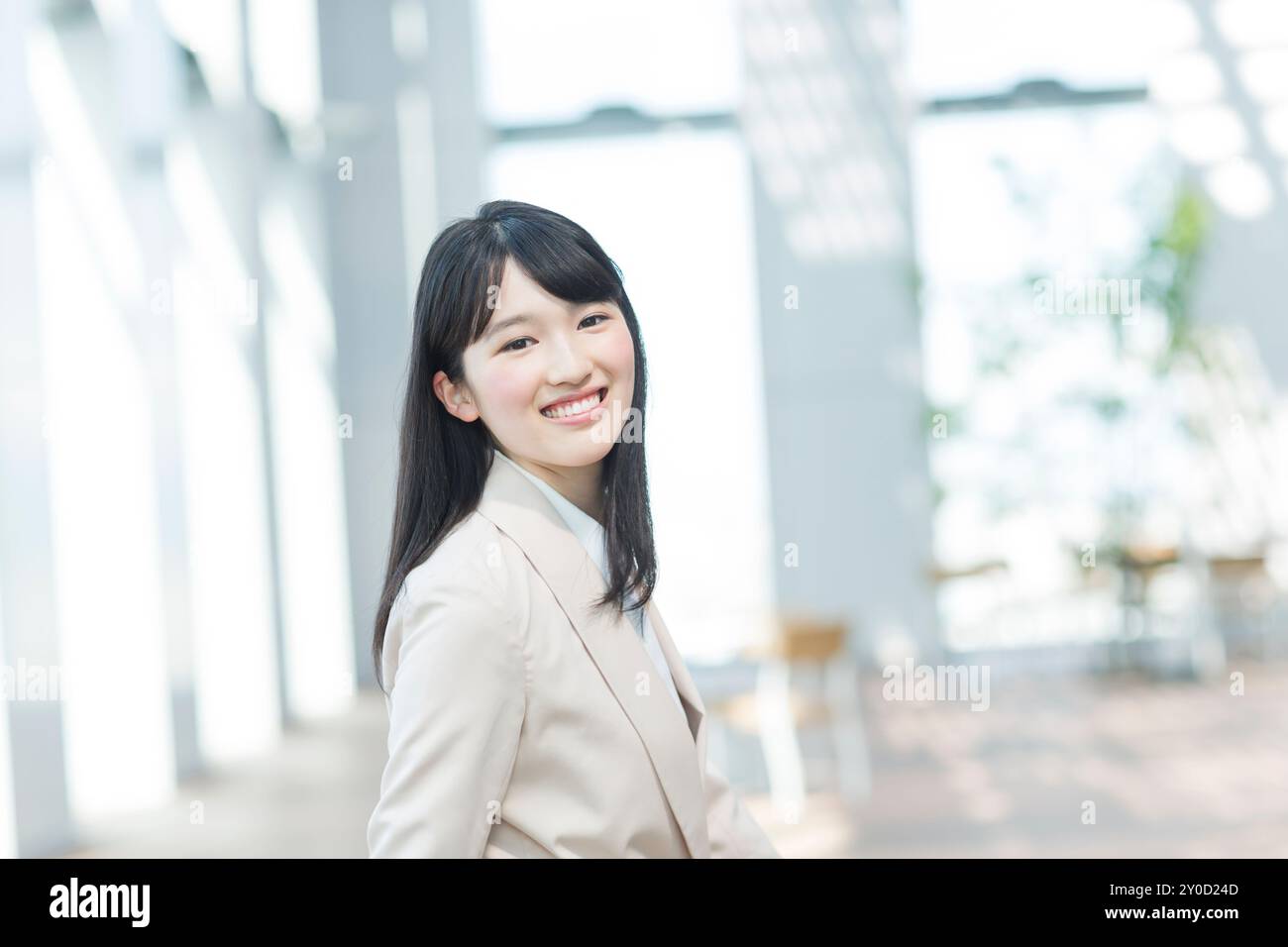 Businesswoman?turning around with smile Stock Photo - Alamy