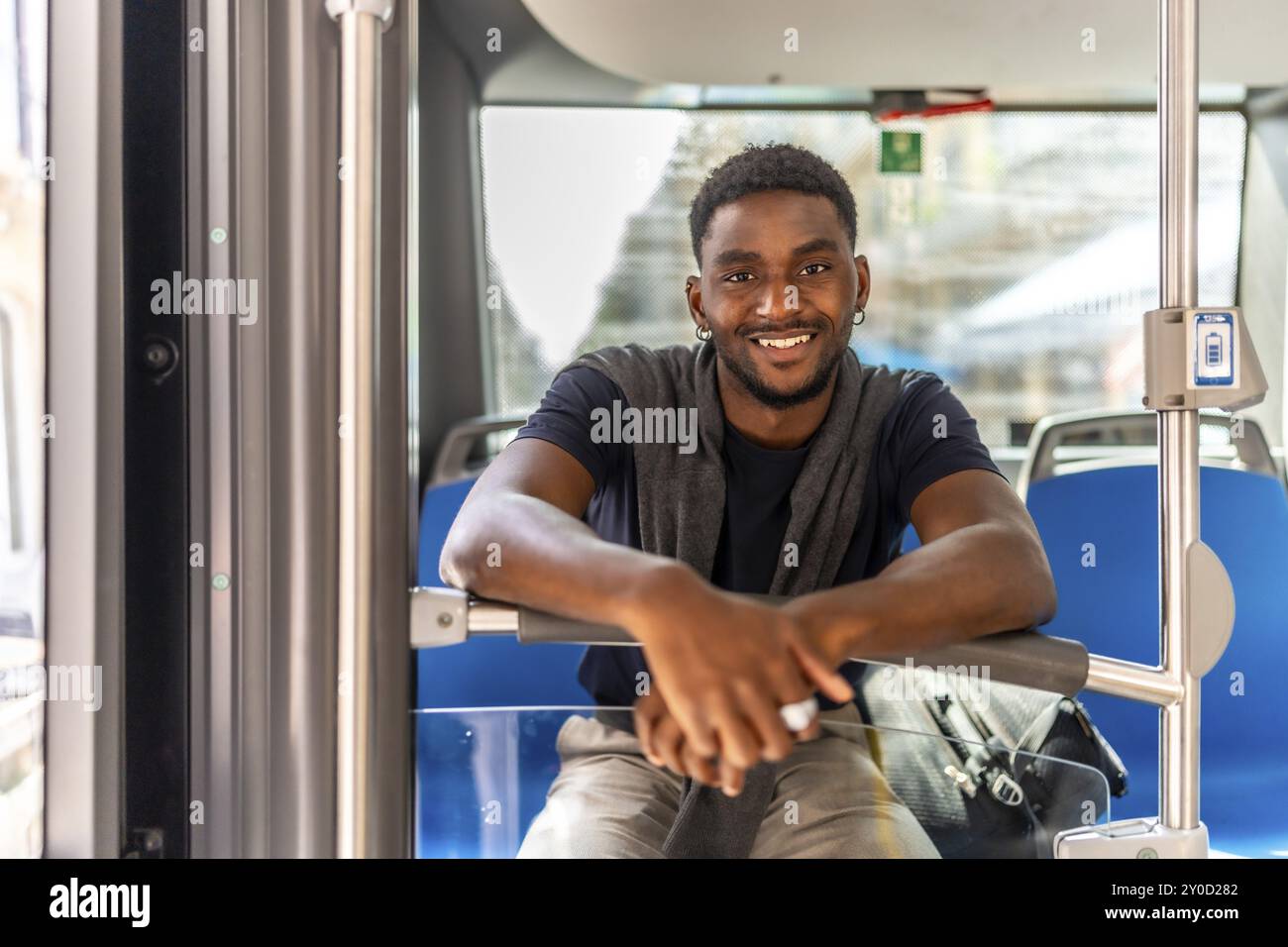 Portrait of a happy african man sitting on the public bus on the way to ...