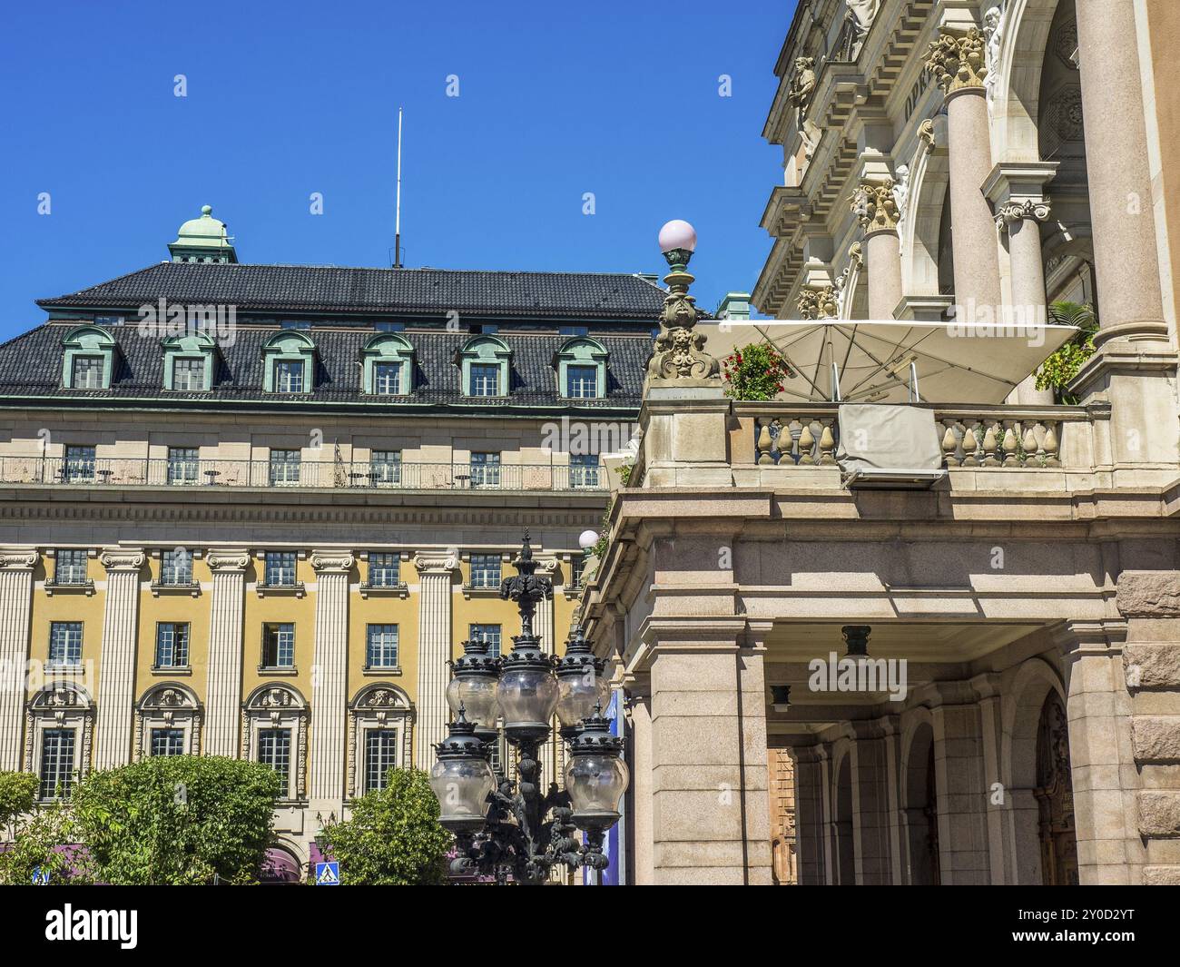 Historic buildings with balconies and windows, trees in front, under a ...