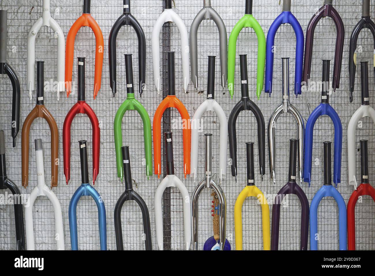 Front bicycle forks in various colors at wall Stock Photo - Alamy