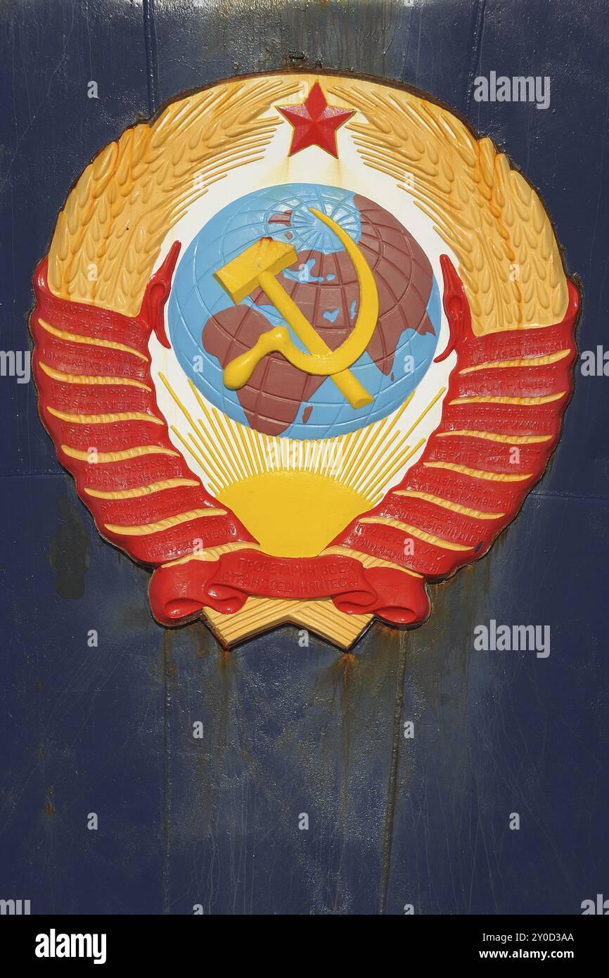 Soviet emblem featuring hammer and sickle over a globe, surrounded by ...