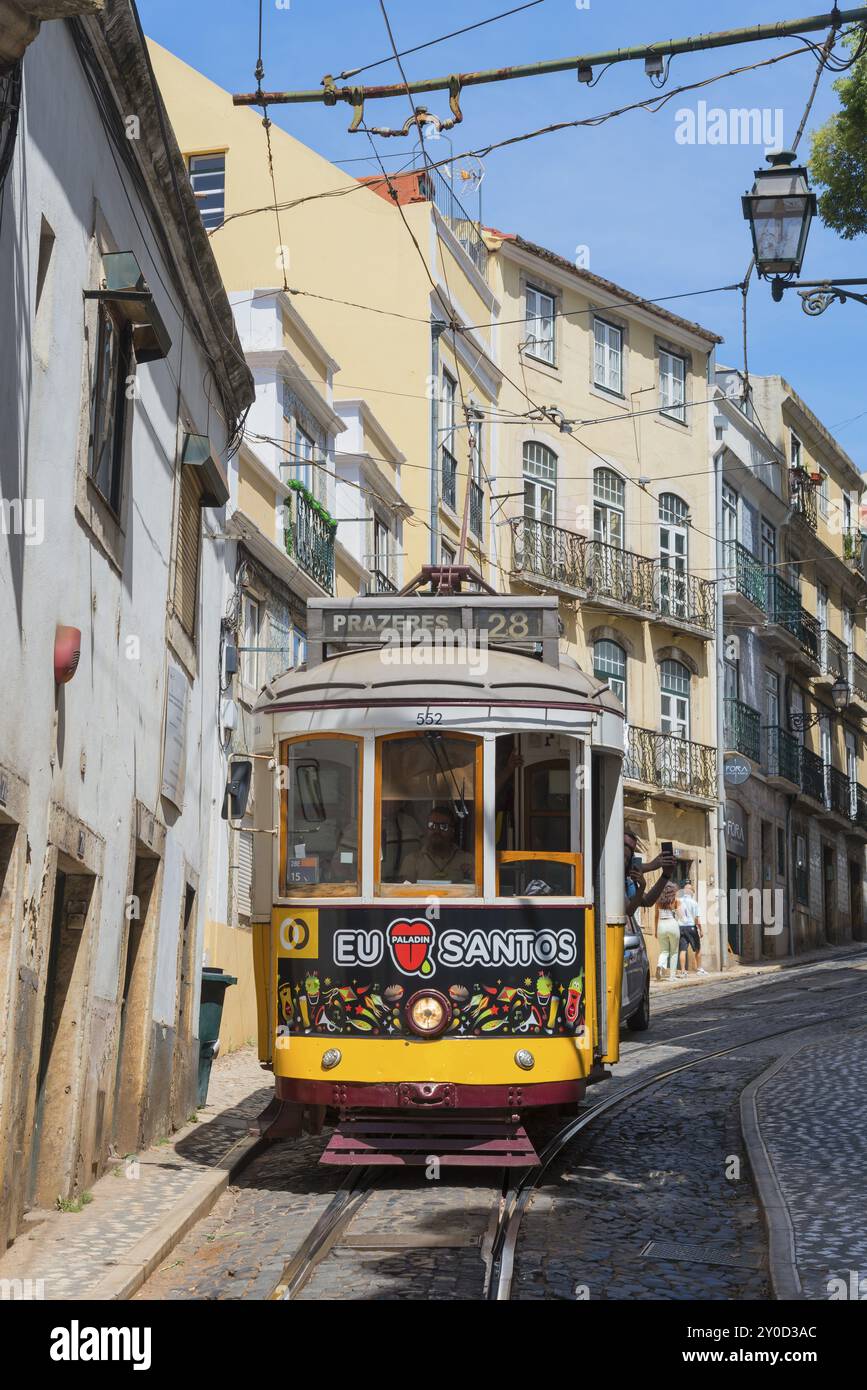 Yellow tram on narrow street lined with historic buildings, Tram, Line ...