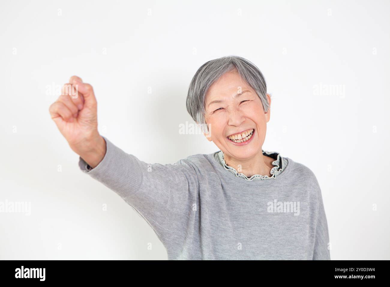 An elderly lady in a triumphant pose Stock Photo - Alamy