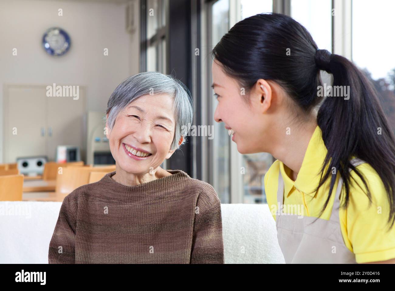 An elderly woman having a conversation with a caregiver Stock Photo - Alamy