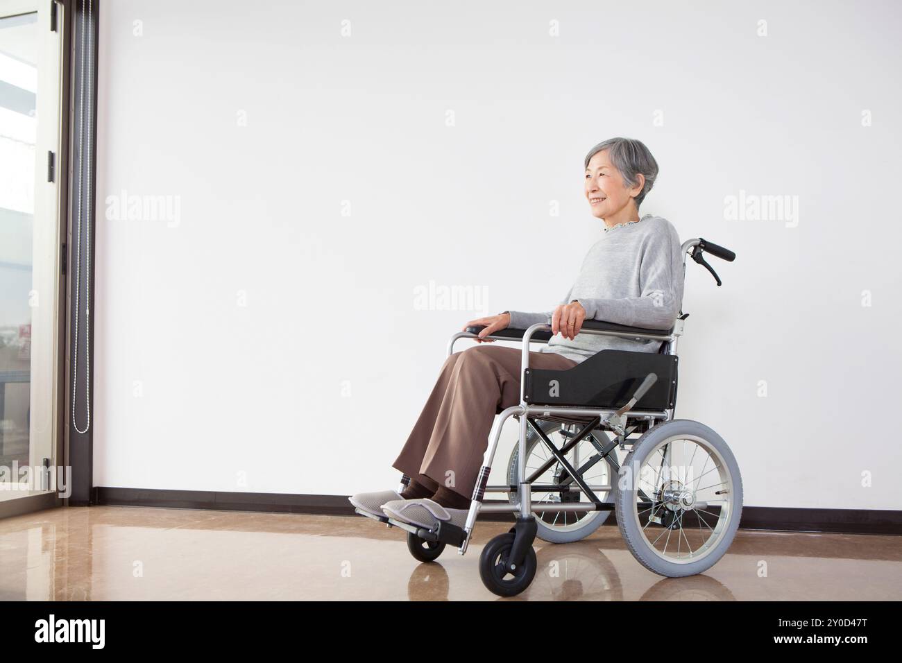 A senior woman on a wheelchair Stock Photo - Alamy