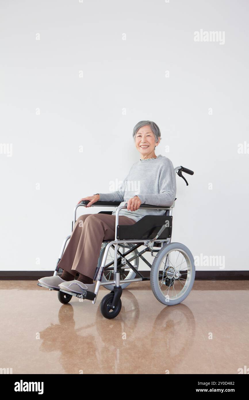 A senior woman on a wheelchair Stock Photo - Alamy