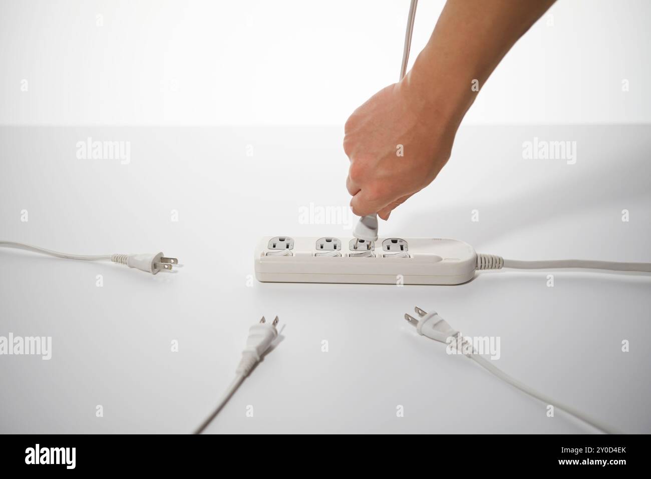 A lot of outlets and plugs, and hands Stock Photo - Alamy