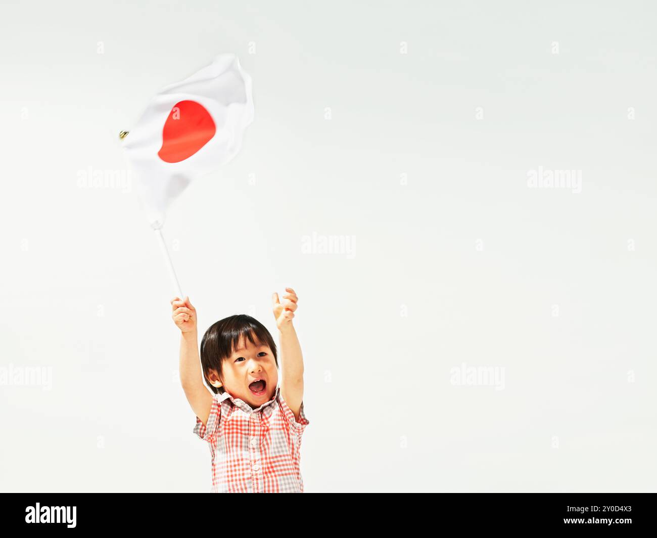 Boy waving the national flag of Japan Stock Photo - Alamy