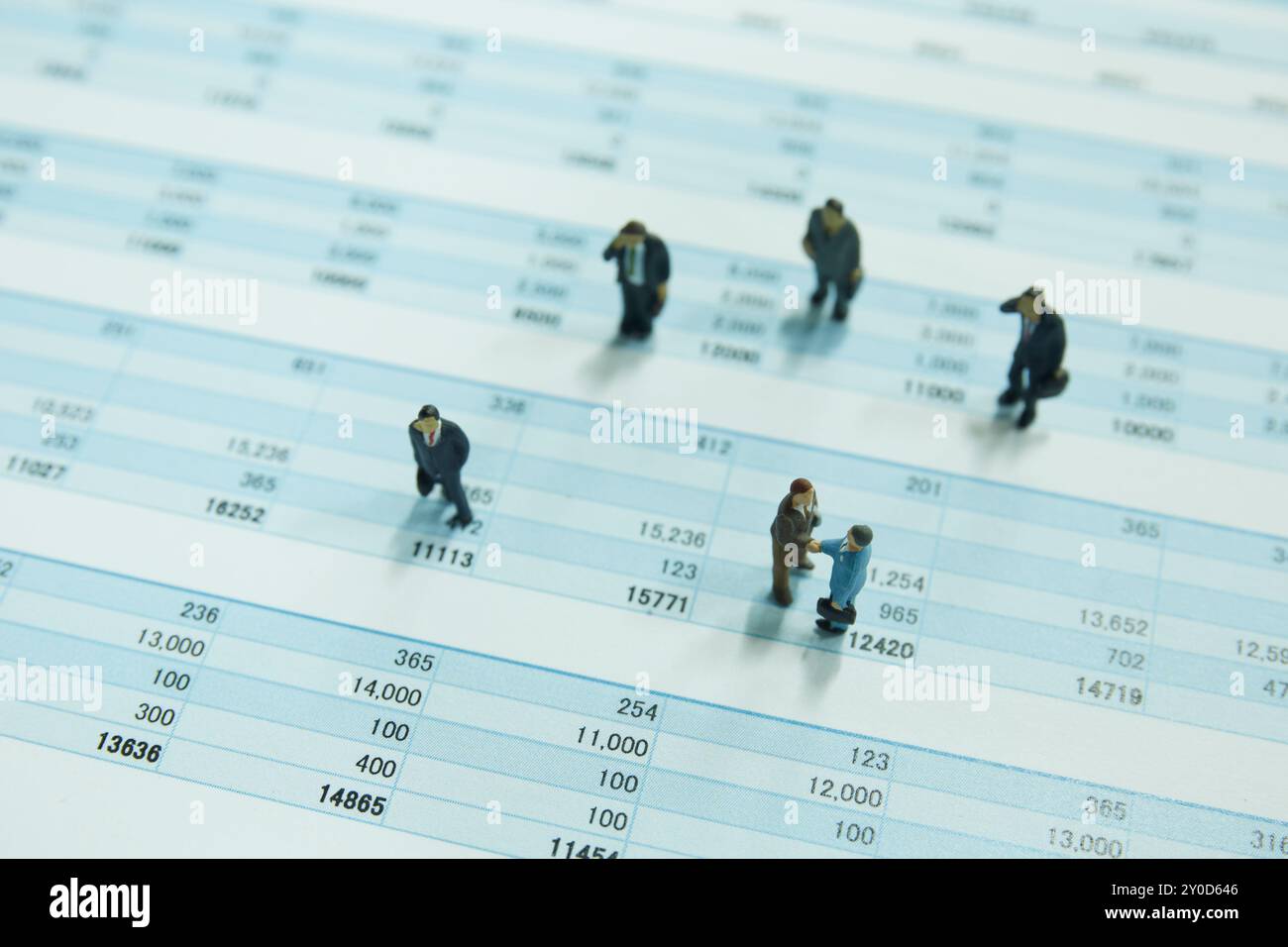 A lot of office worker figures standing on result sheet Stock Photo - Alamy