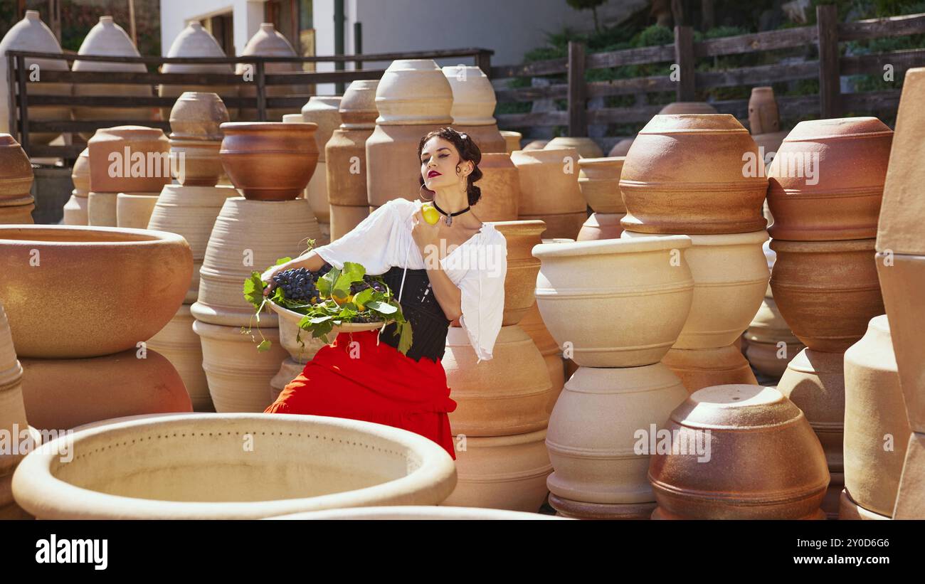 Grapes in hand, woman strikes thoughtful pose, surrounded by intricate ...