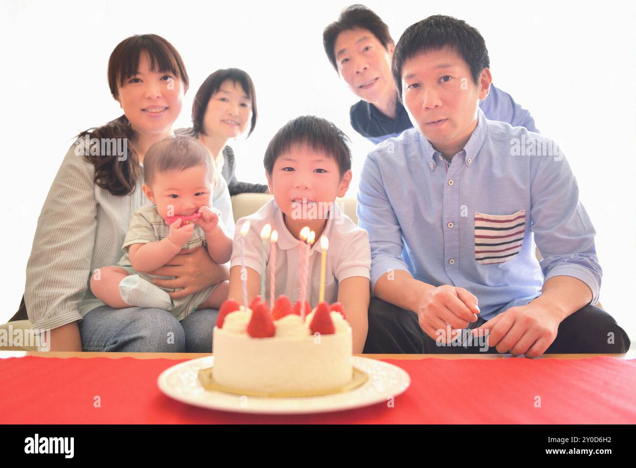 Babies and three generations family with birthday cake Stock Photo - Alamy