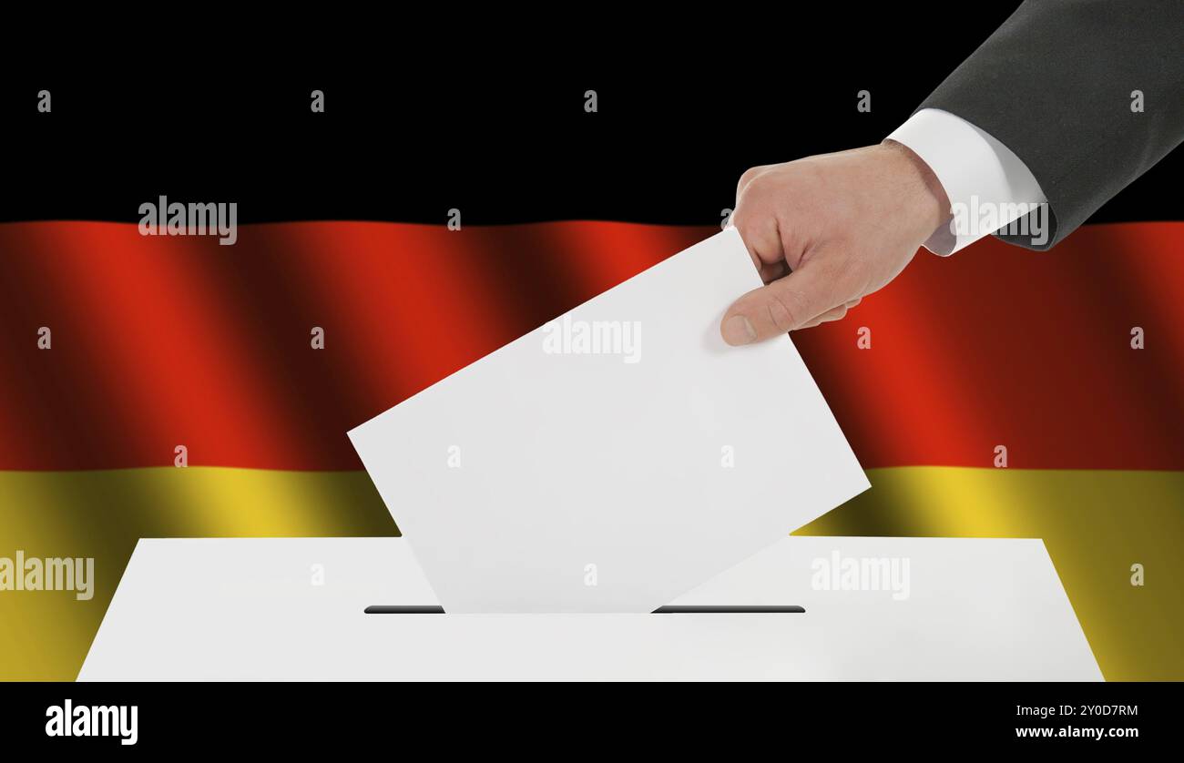 The German flag and the hand with the bulletin about the ballot box ...
