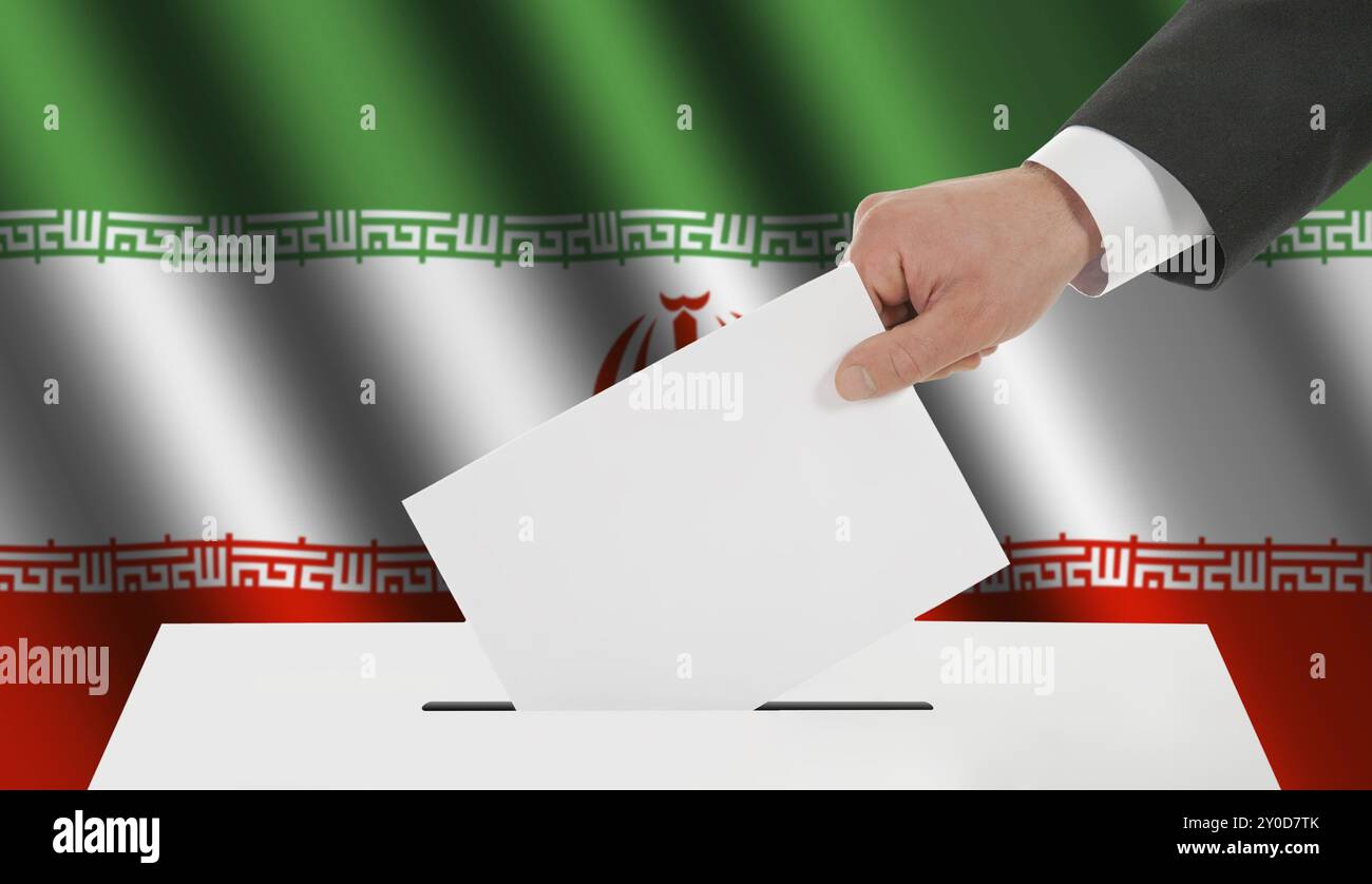 The Iranian flag and the hand with the bulletin about the ballot box ...