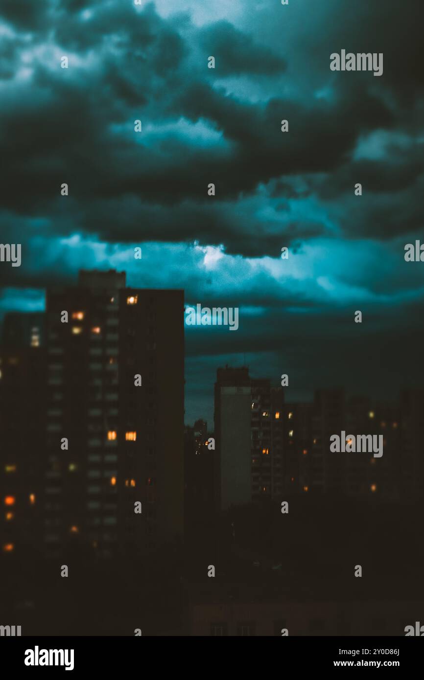 A night city with multi-story apartment buildings under dark blue ...
