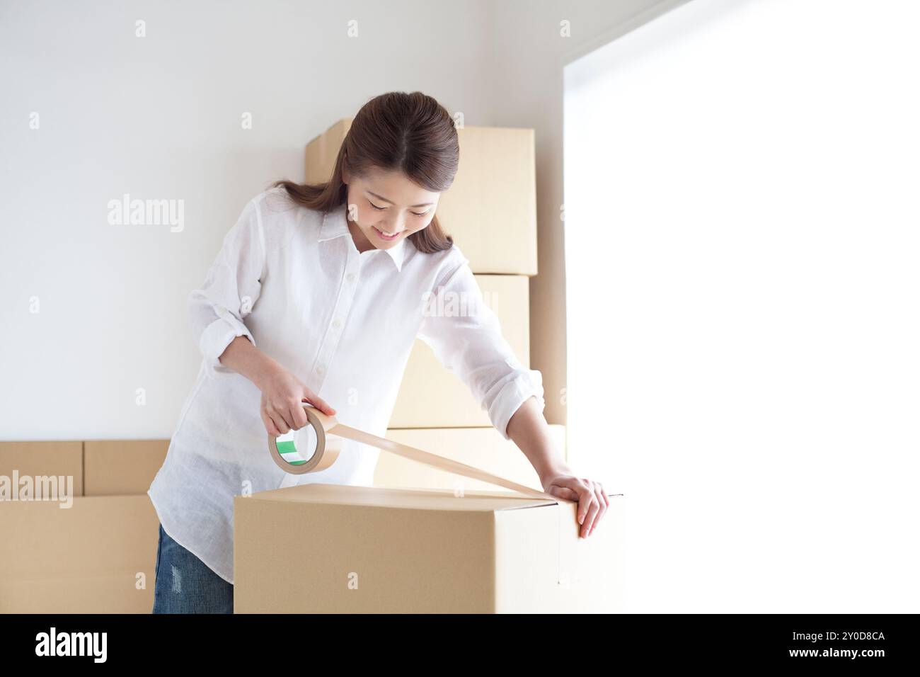 A woman busy preparing for a move Stock Photo - Alamy