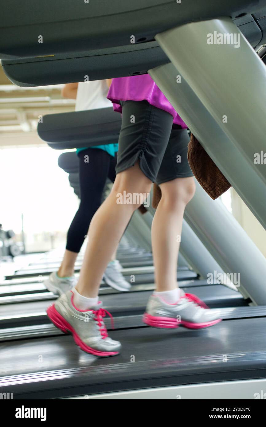 Feet of a woman running on a treadmill Stock Photo - Alamy
