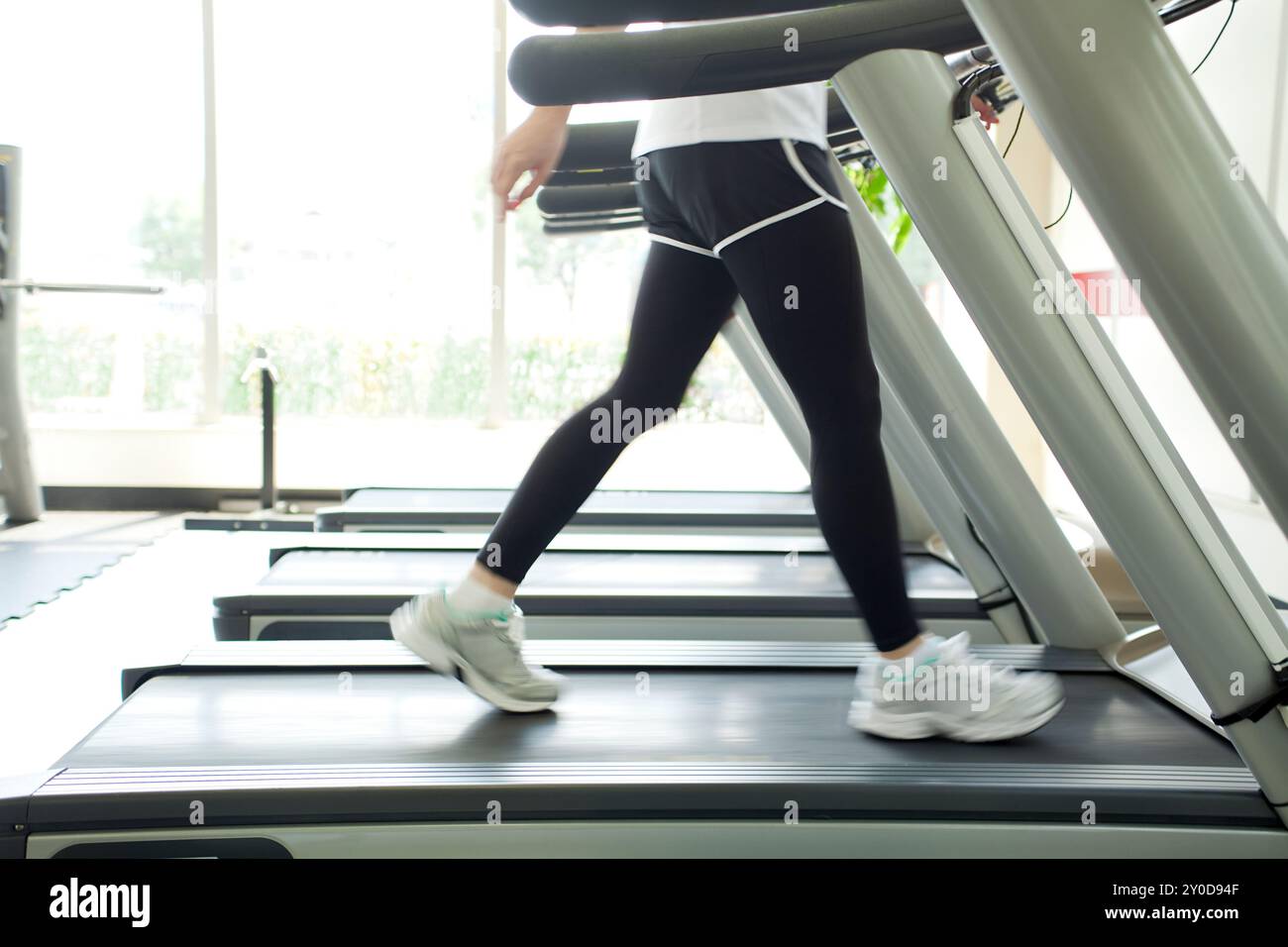 Feet of a woman exercising on a treadmill Stock Photo - Alamy