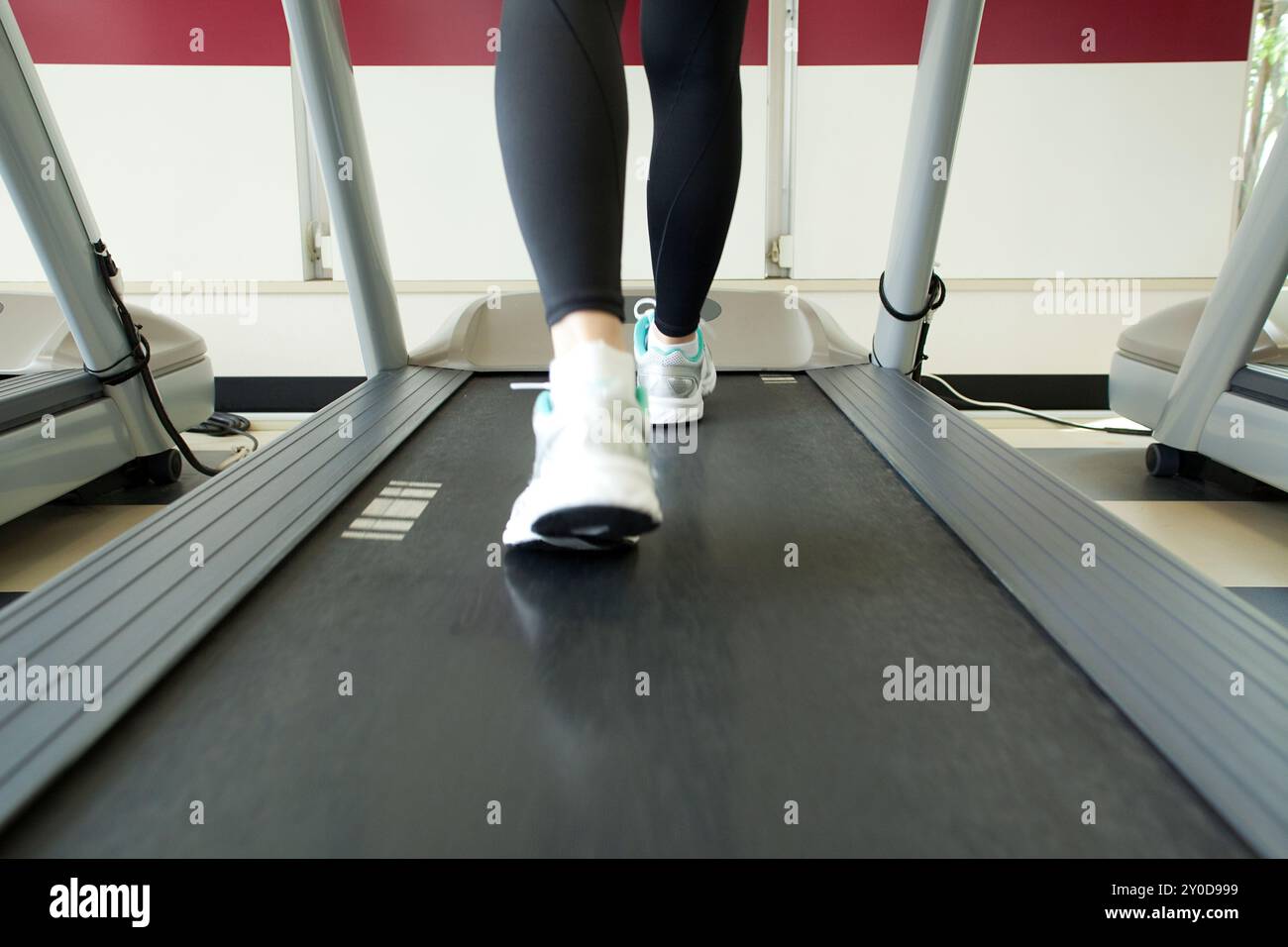 Feet of a woman exercising on a treadmill Stock Photo - Alamy
