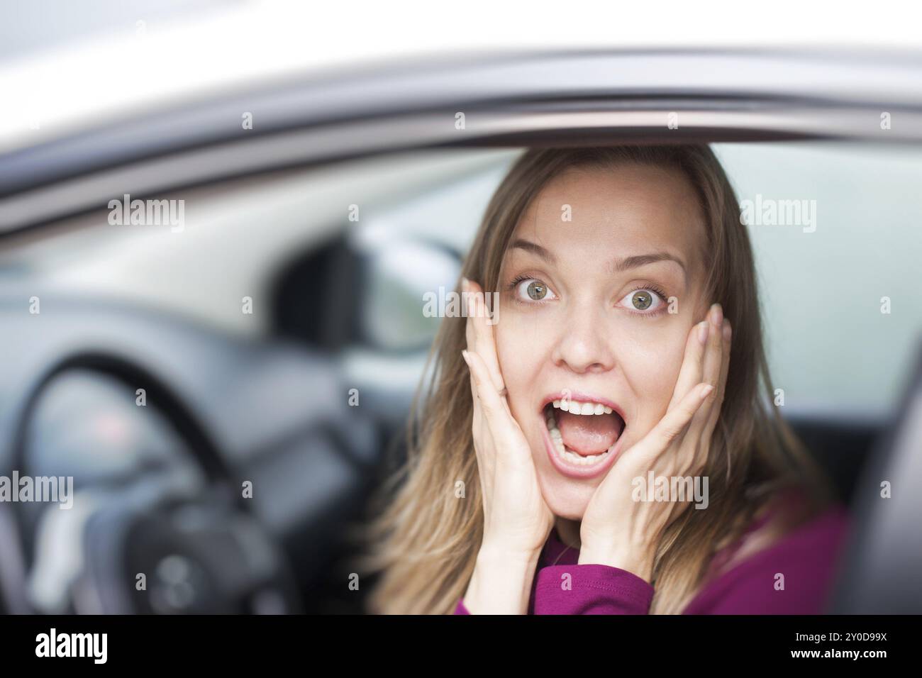 Shocked woman in a car Stock Photo - Alamy