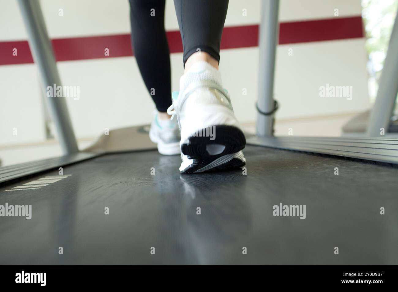 Feet of a woman exercising on a treadmill Stock Photo - Alamy
