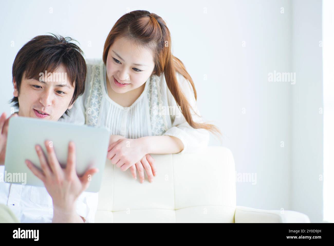 Couple staring at tablet Stock Photo - Alamy