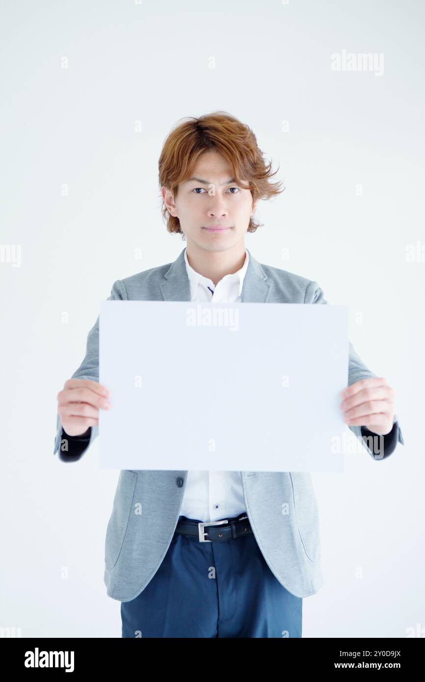 A man holding a message board Stock Photo - Alamy