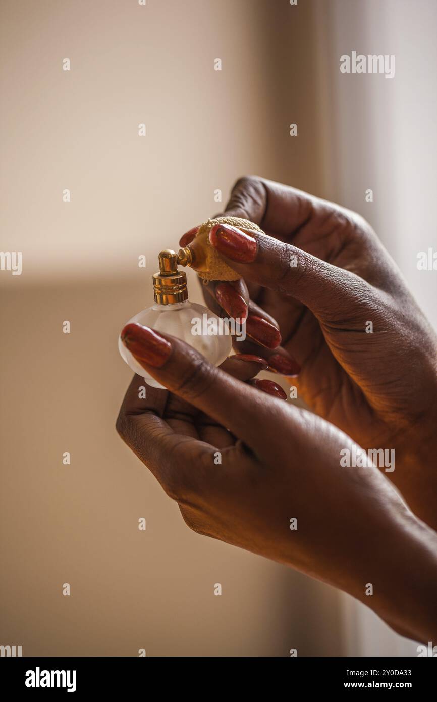 Hands holding a bottle of perfume Stock Photo - Alamy