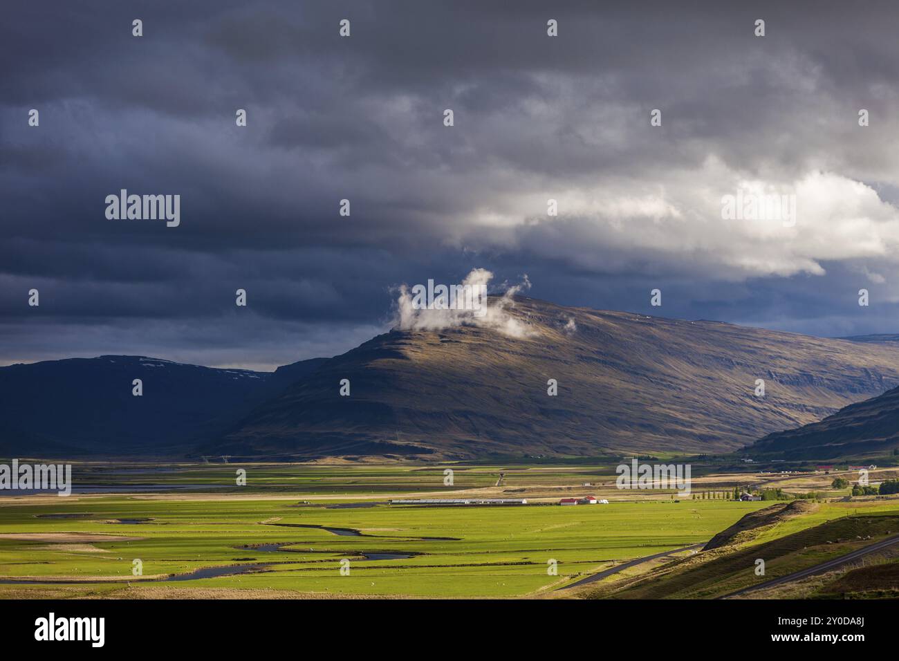 Mountain under a gray overcast sky with an interestingly shaped white ...